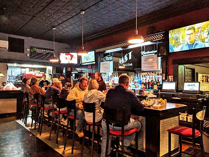 The bar area buzzes with energy as regulars and newcomers alike gather for great food and conversation.