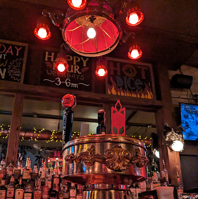 The bar area glows with warm light, copper accents, and a carefully curated selection of spirits that complement their famous pies.