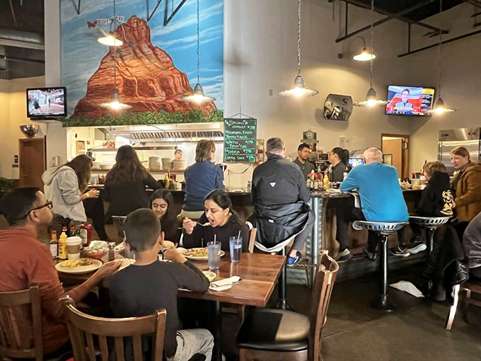 A full house of diners experiencing the communal joy that comes from sharing space where good food happens.