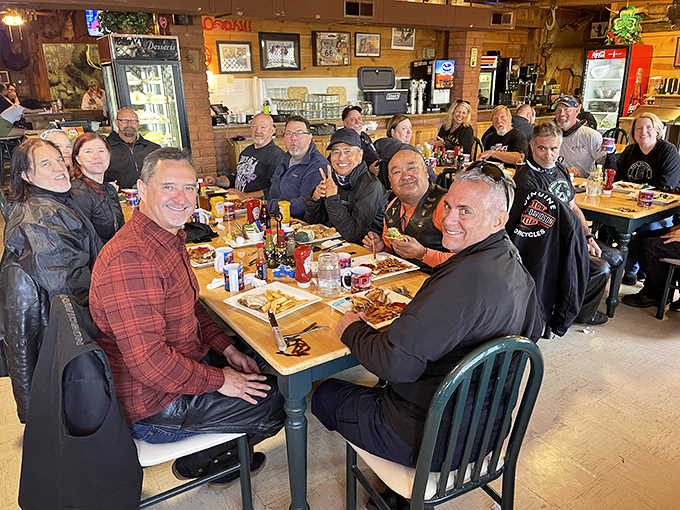 Happy diners gathered around tables laden with hearty fare &ndash; strangers becoming friends over shared food adventures.