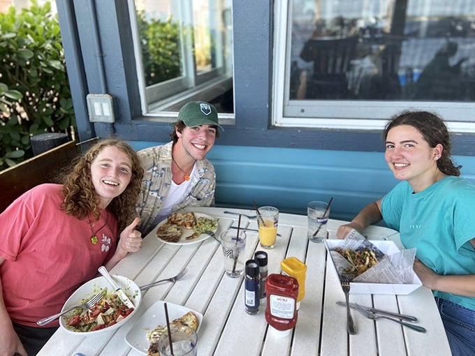 Happy diners enjoying fresh seafood and sunshine&mdash;the Stuart Boathouse experience distilled into one perfect moment.
