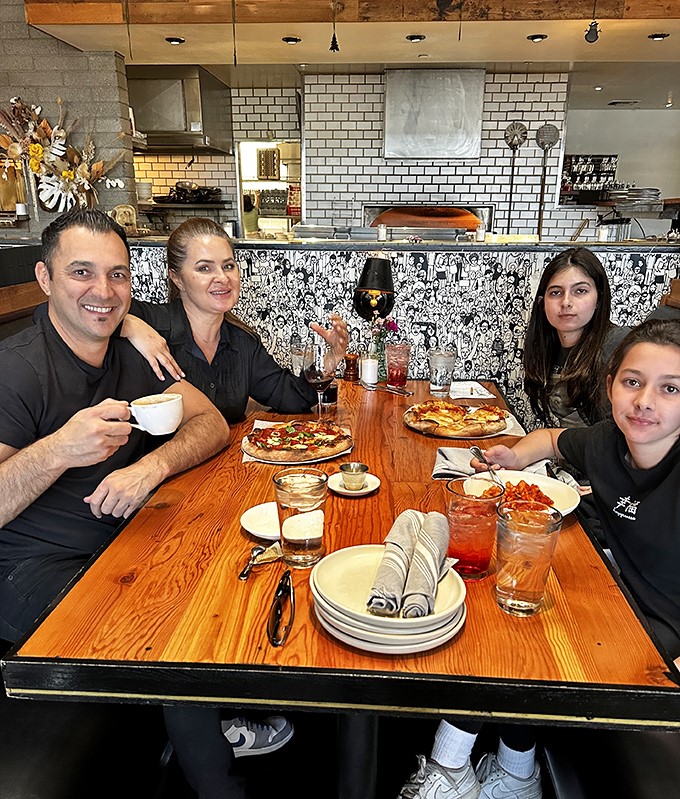 Happy diners enjoying the fruits of The Parlor's labor &ndash; where every meal feels like a celebration of good food, good company, and the joy of discovery.