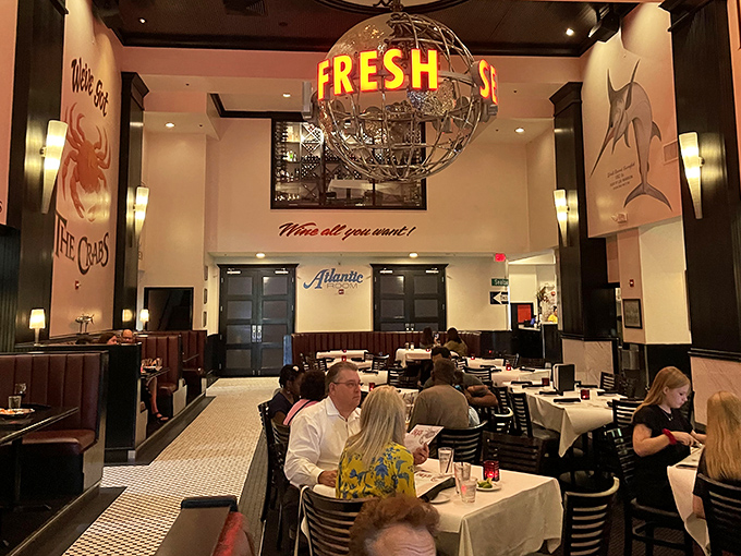 The dining room hums with satisfaction as the "FRESH" globe chandelier presides over tables of happy diners enjoying oceanic treasures below.