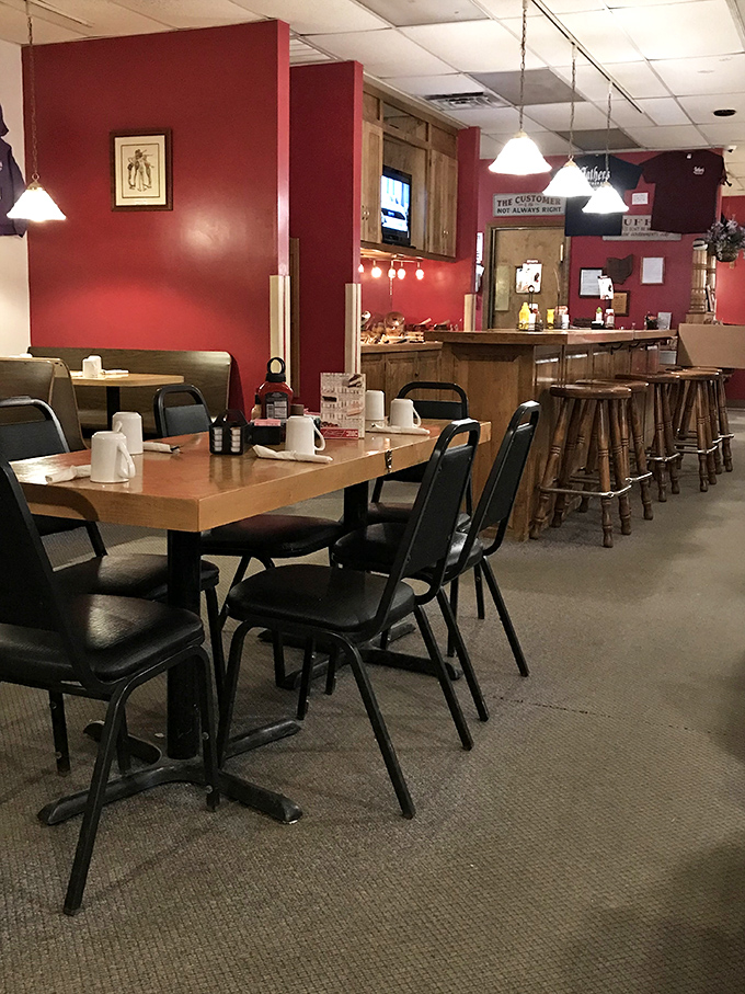 The dining room's warm red walls and wooden accents create the perfect backdrop for memorable meals and conversations that flow as easily as the coffee.