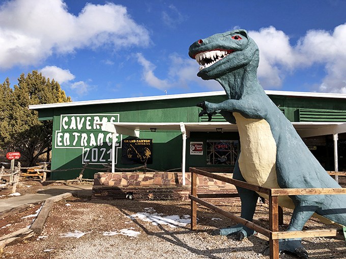 This friendly dinosaur sentinel guards the cavern entrance, a delightfully kitschy ambassador welcoming visitors to the underground world below.
