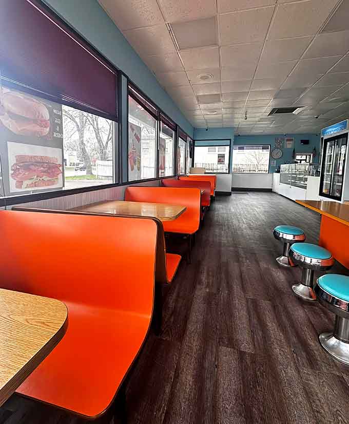 Orange booths and wood-grain tables create a retro vibe that says "we're here for the food, not the Instagram likes."