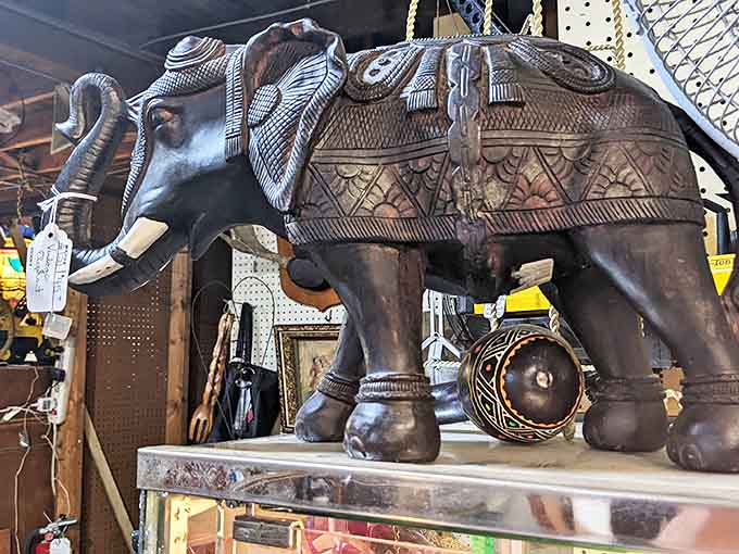 This intricately carved pachyderm with its ornate saddle and detailed trunk stands ready to bring exotic charm to someone's bookshelf.