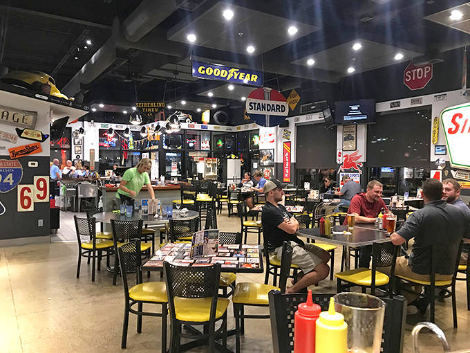 Conversations flow as freely as the beverages in this gathering space where strangers become friends over shared plates and automotive nostalgia.