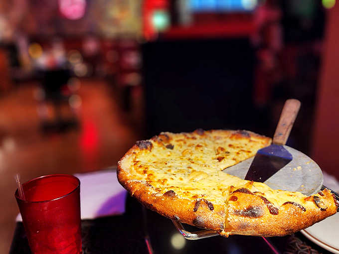 A melty masterpiece where multiple cheeses unite in bubbling harmony atop a crust that's achieved the perfect balance of chew and crunch.