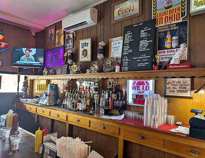 The well-stocked bar ready to pour cold ones, with memorabilia covering every available wall space.
