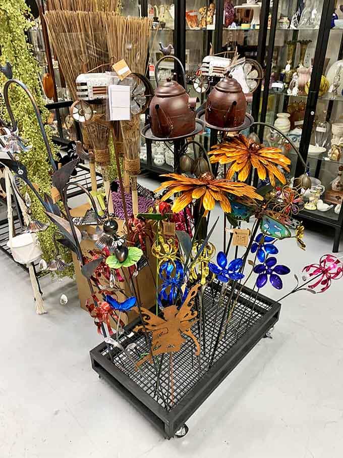Garden whimsy comes alive through metal flowers and rustic accessories that bring personality to outdoor spaces in ways big box stores never could.
