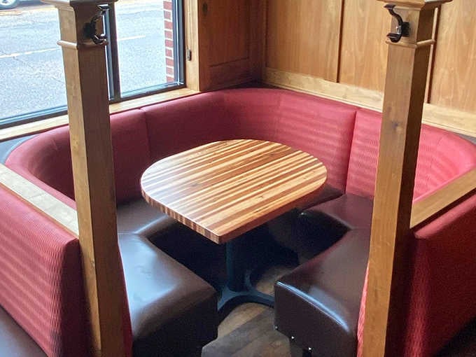 These intimate corner booths, with their cherry-red upholstery, provide the perfect spot for quiet conversations and lingering meals.