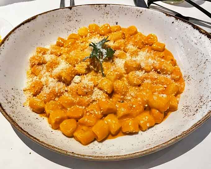 That vibrant orange vodka sauce coating tender gnocchi is basically comfort food wearing its Sunday best.