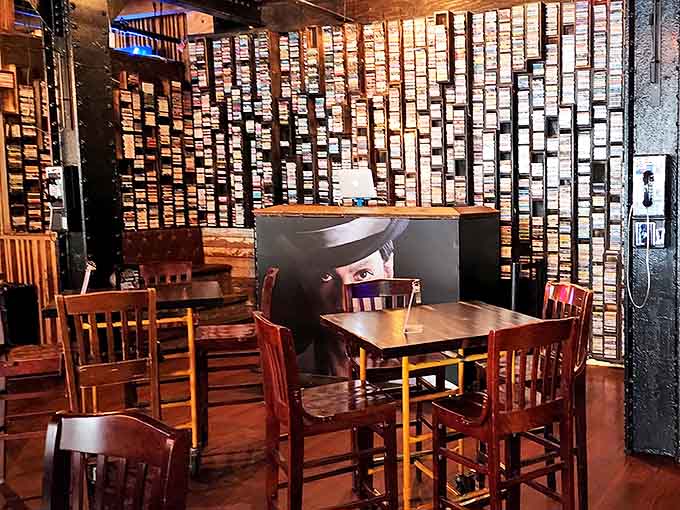 Exposed brick and vintage game cartridges create a dining area that's part industrial chic, part nostalgic time capsule, all awesome.