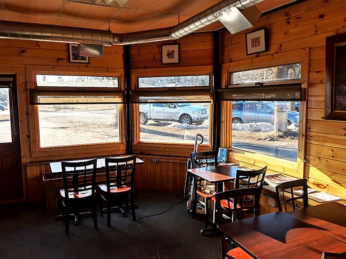 Sun-drenched seating where windows frame views of Grand Marais &ndash; the perfect spot to plan your day's adventures.