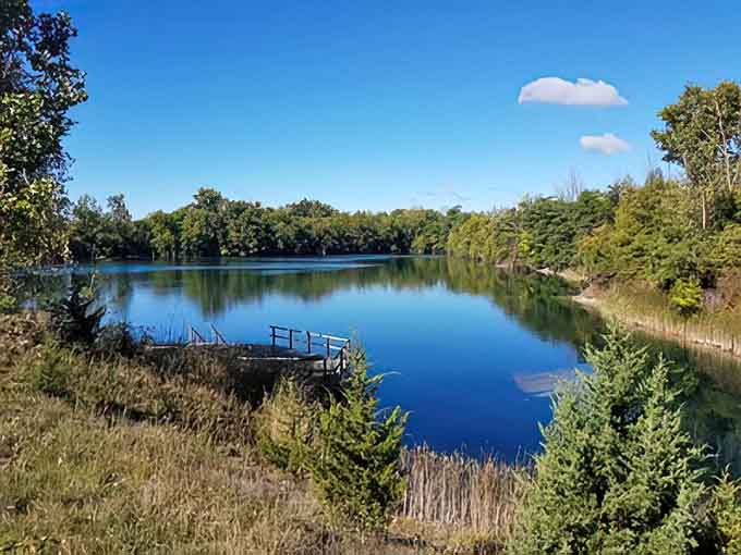 The local fishing spot mirrors clouds and dreams alike, its still waters promising both reflection and the occasional trophy bass.