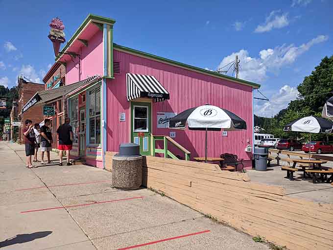 That pink building isn't just serving ice cream, it's serving happiness in a cone, one scoop at a time to grateful visitors.