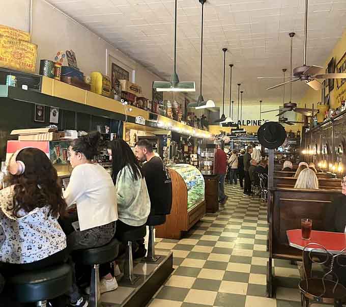 The bustling counter scene captures the community spirit that made diners the social media of their era, minus the algorithms.