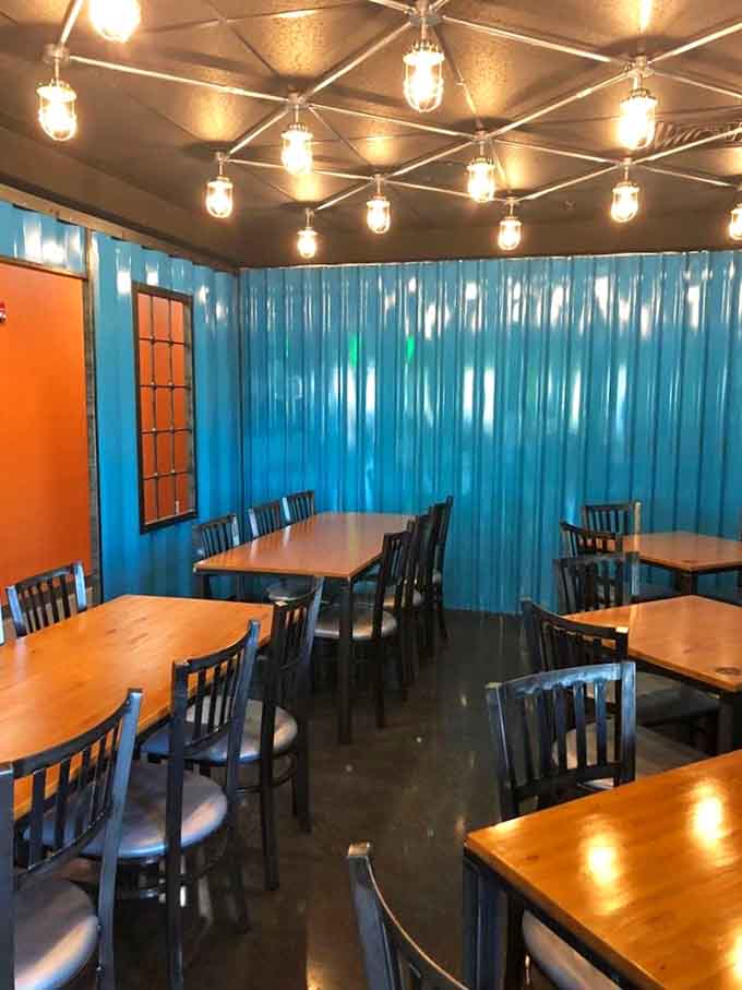 A private party room with blue corrugated walls and string lights offers a festive space for special celebrations.