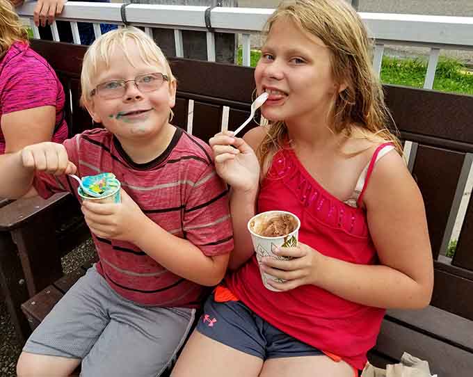 Young customers tackle their treats with the determination of mountaineers, faces already showing evidence of the delicious battle ahead.