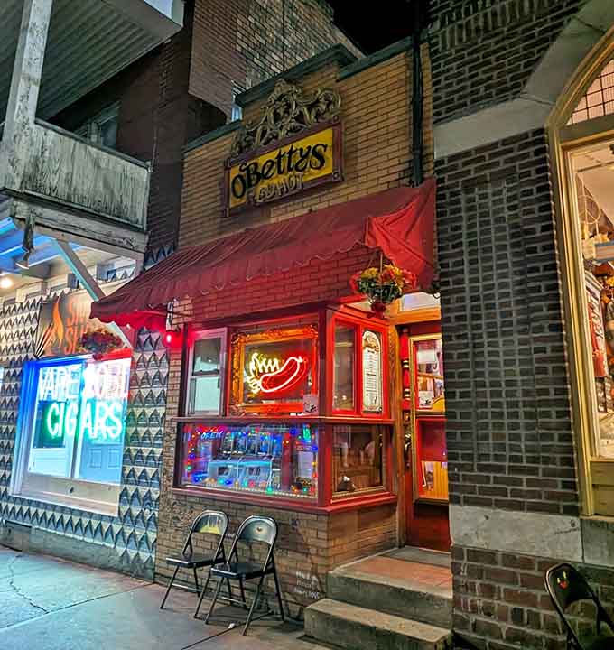 As darkness falls, O'Betty's neon hot dog sign glows like a beacon, drawing hungry night owls to this theatrical temple of frankfurter perfection.