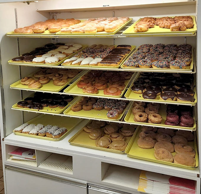 Display cases lined with yellow trays full of fresh donuts, a sight that makes morning people out of even the grumpiest night owls.