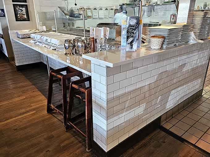 Clean white subway tiles and professional equipment signal serious baking business happening behind that counter every single day.