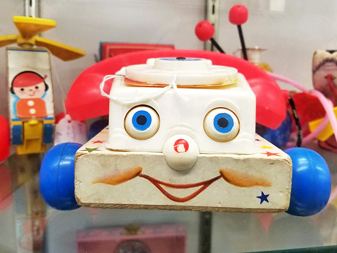 This vintage toy telephone with its cheerful face once delighted children long before screens dominated playtime.