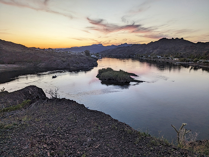 Sunset transforms the Colorado River into liquid gold, while an island creates the perfect focal point for nature's nightly show.