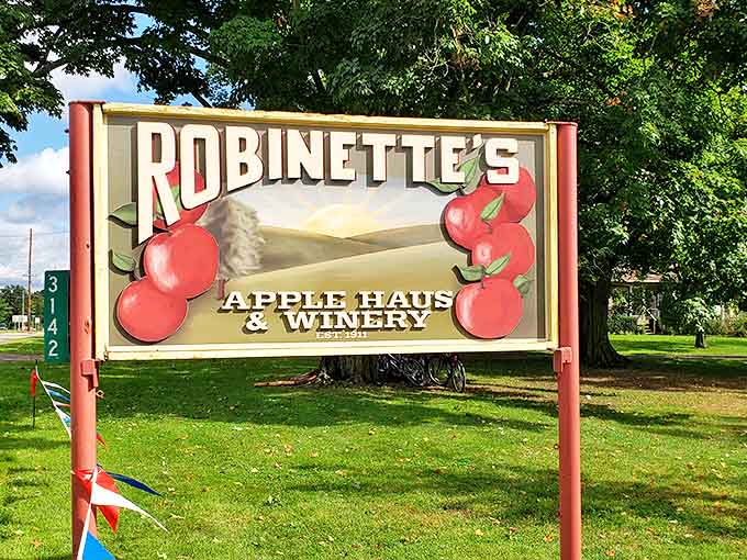 The iconic Robinette's sign stands as a beacon of hope for travelers seeking refuge from pumpkin spice overload with authentic apple goodness.