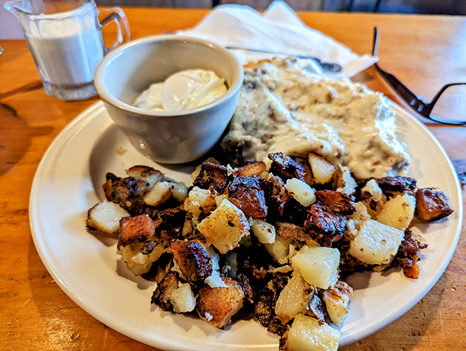 Comfort on a plate: crispy home fries and creamy sausage gravy that would make any Southern grandmother nod in respectful approval.