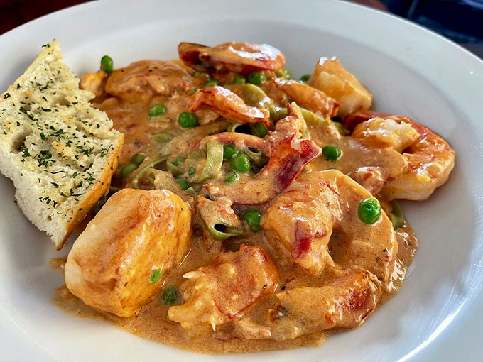 Seafood Alfredo that defies gravity &ndash; tender shrimp and lobster chunks suspended in a sauce so silky it should be illegal. Garlic bread for essential sauce-mopping.