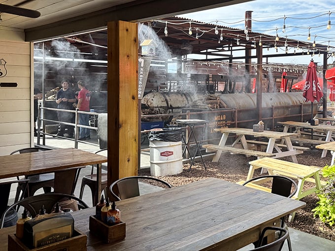 Behind clear windows, the smoking pit reveals barbecue's open secret: patience transforms tough cuts into tender treasures through smoke and time.