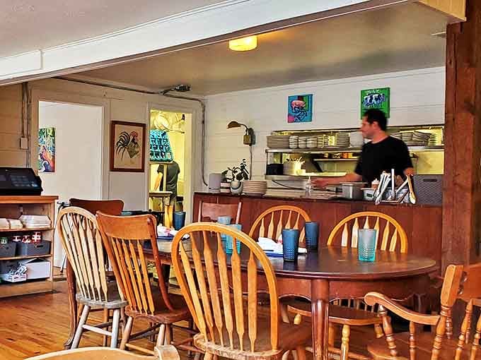 The open kitchen design lets diners witness the careful choreography that transforms simple ingredients into extraordinary Southern comfort food.