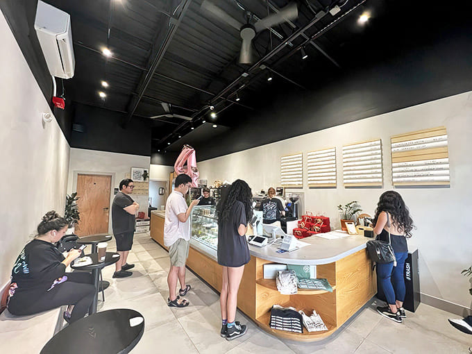 The weekend rush brings dessert enthusiasts from near and far, all patiently waiting for their turn at sweet satisfaction.