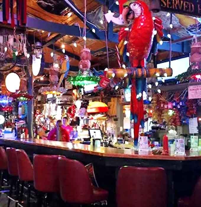 The bar area, where stories flow as freely as the drinks, and every stool offers a different vantage point of the memorabilia madness.