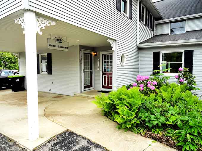 The guest entrance welcomes visitors with understated charm, ferns and flowers nodding hello as you step into your temporary home away from home.