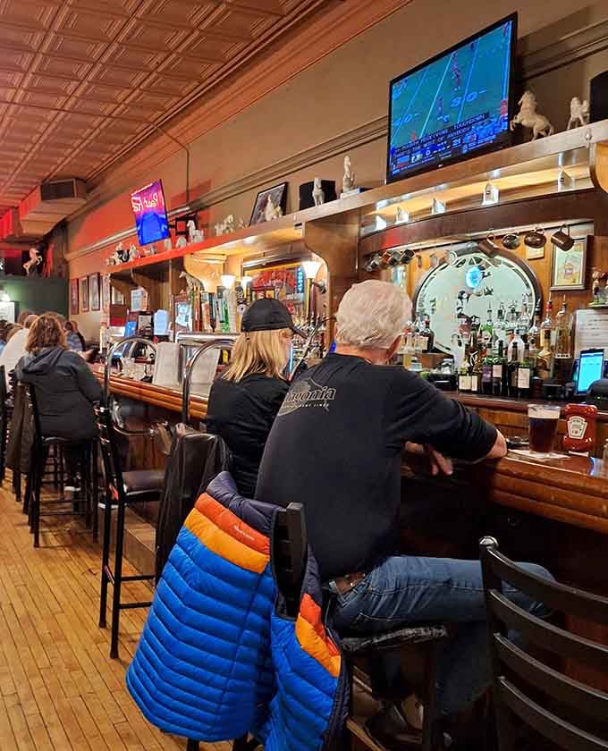 Locals belly up to the bar like regulars do, creating that warm community atmosphere that makes great restaurants feel like home.