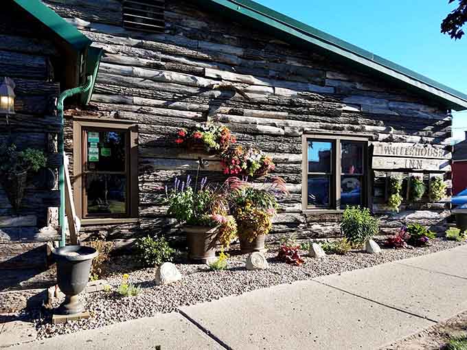 The charming exterior welcomes guests with flowers and rustic appeal that promises good things are happening inside those weathered walls.