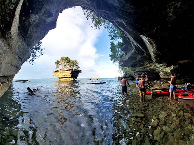 The thrill of discovery awaits as kayakers venture beneath overhanging rock formations, where every paddle stroke reveals new geological wonders.