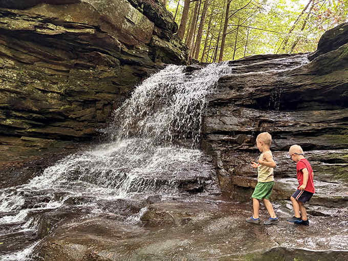 Young explorers discover the simple joy of splashing in nature's playground, creating memories that will outlast any video game achievement.