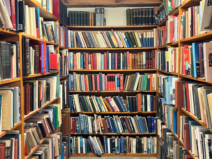 Floor-to-ceiling bookshelves create a bibliophile's paradise where literary treasures await new homes and eager readers.