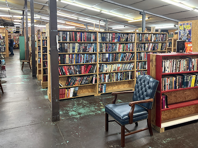 A dignified leather chair invites weary browsers to sit awhile, test-driving potential purchases in comfort before committing.