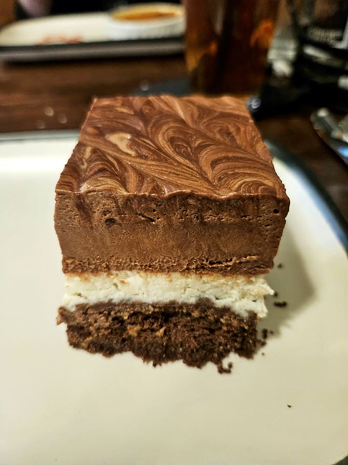 The Guinness Chocolate Cake reveals three distinct layers of decadence – a chocolate lover's dream where the stout adds depth without overwhelming the palate.