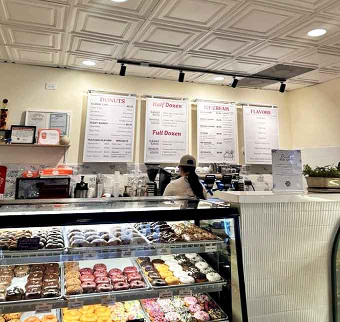 Behind the counter, where donut magic happens daily, staff prepare to fulfill sweet dreams one order at a time.