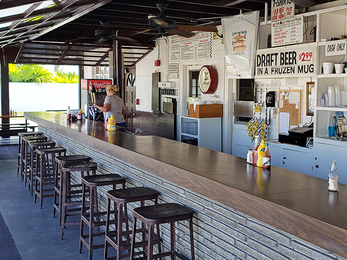The bar seating offers front-row views of the operation, where cold draft beers in frozen mugs perfectly complement the parade of smoked delicacies.