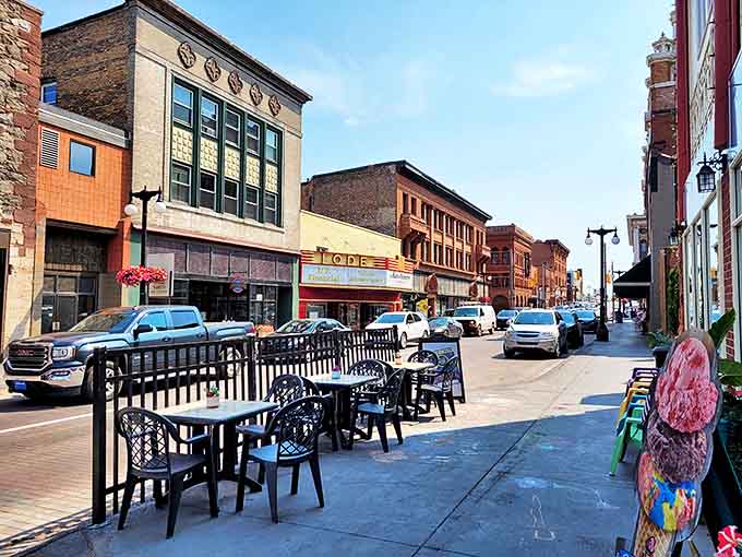 Outdoor dining along Shelden Avenue invites visitors to savor both local cuisine and people-watching, the essence of small-town pleasure.