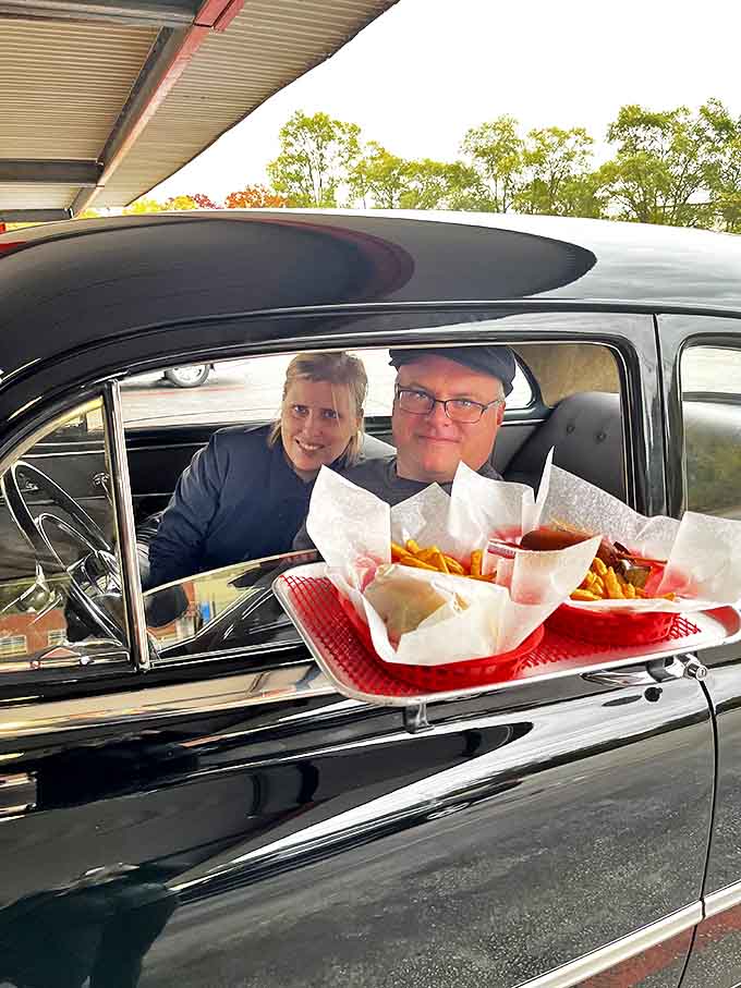 The quintessential drive-in experience &ndash; classic car, window tray, and delicious food creating memories that last longer than the meal itself.