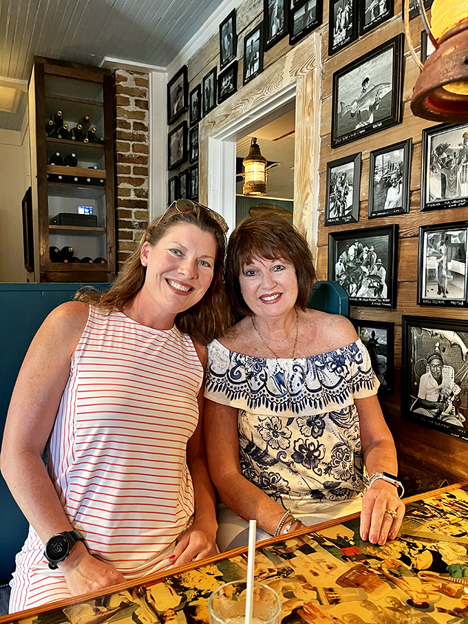 The wall of framed photographs tells stories of fishing adventures past, while diners enjoy the lively atmosphere, adding authentic character to this beloved Anna Maria Island establishment.