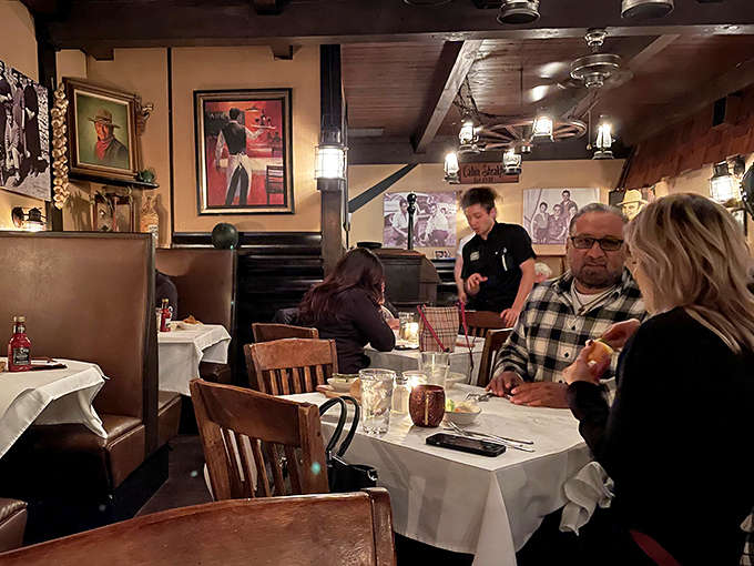 The dining room hums with conversation and clinking glasses as servers glide between tables with the practiced grace of dining room ballet dancers.
